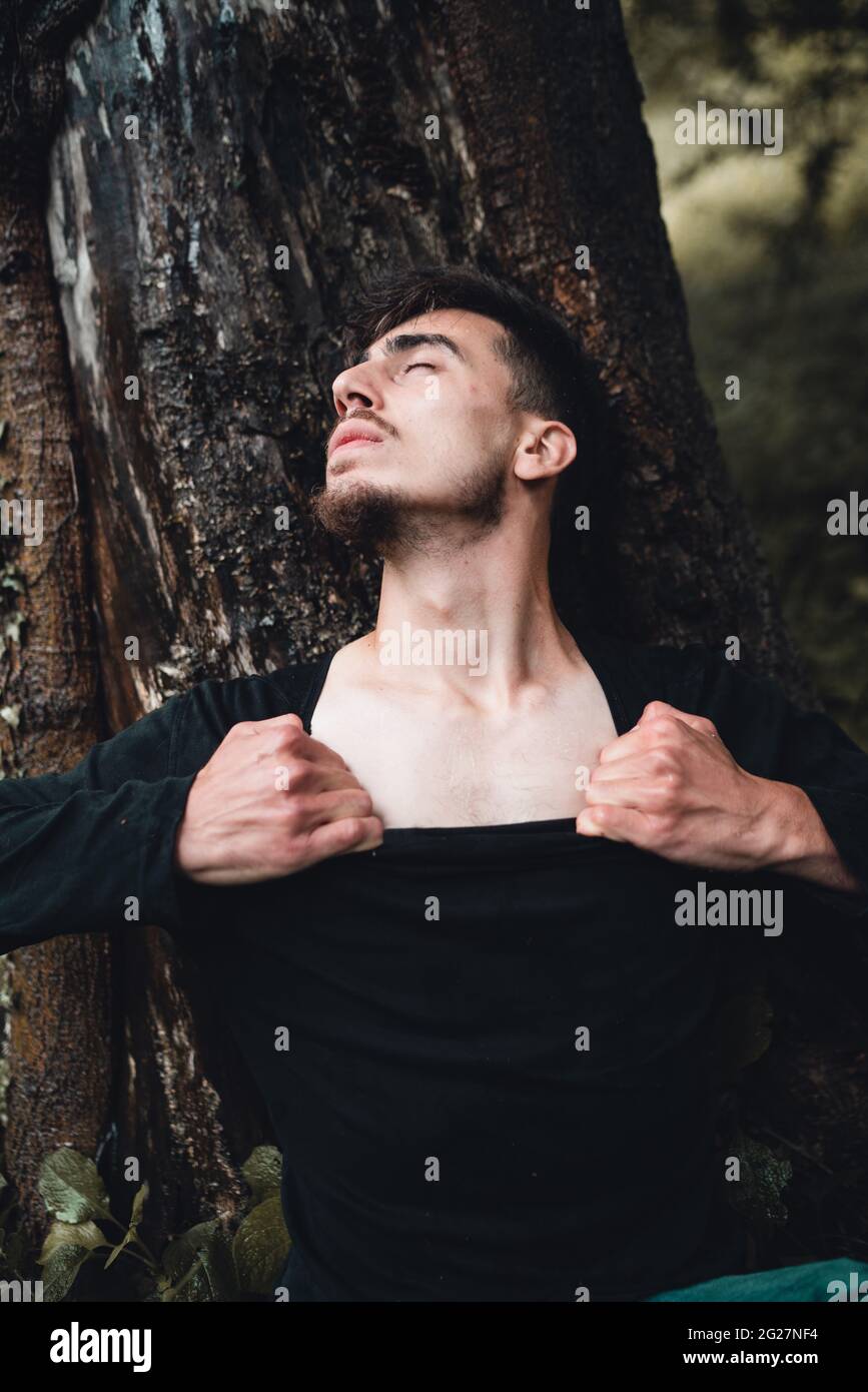 Young man protecting the forest trees, nature and people concept Stock ...