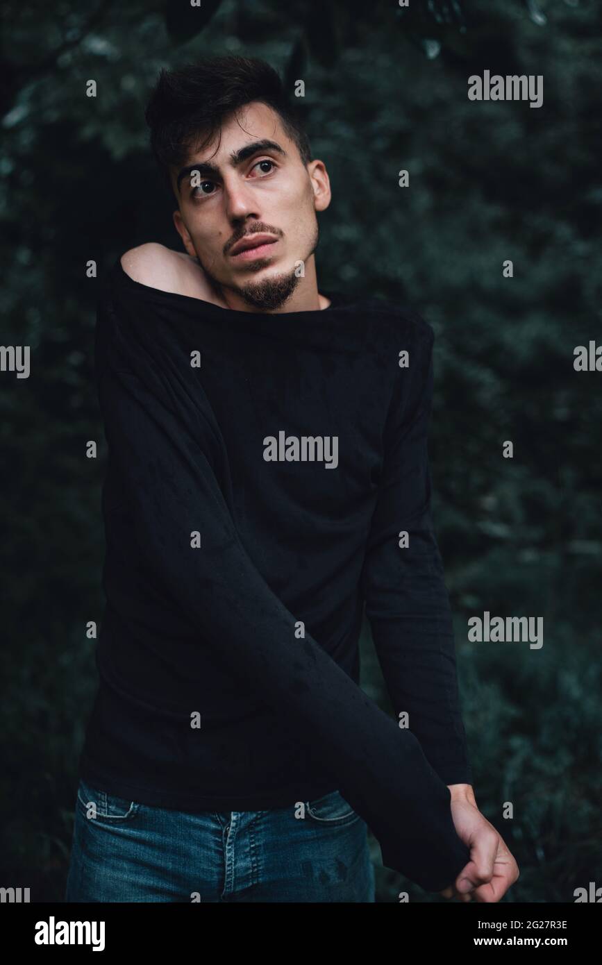 A mad forester man by the trees in the forest Stock Photo - Alamy