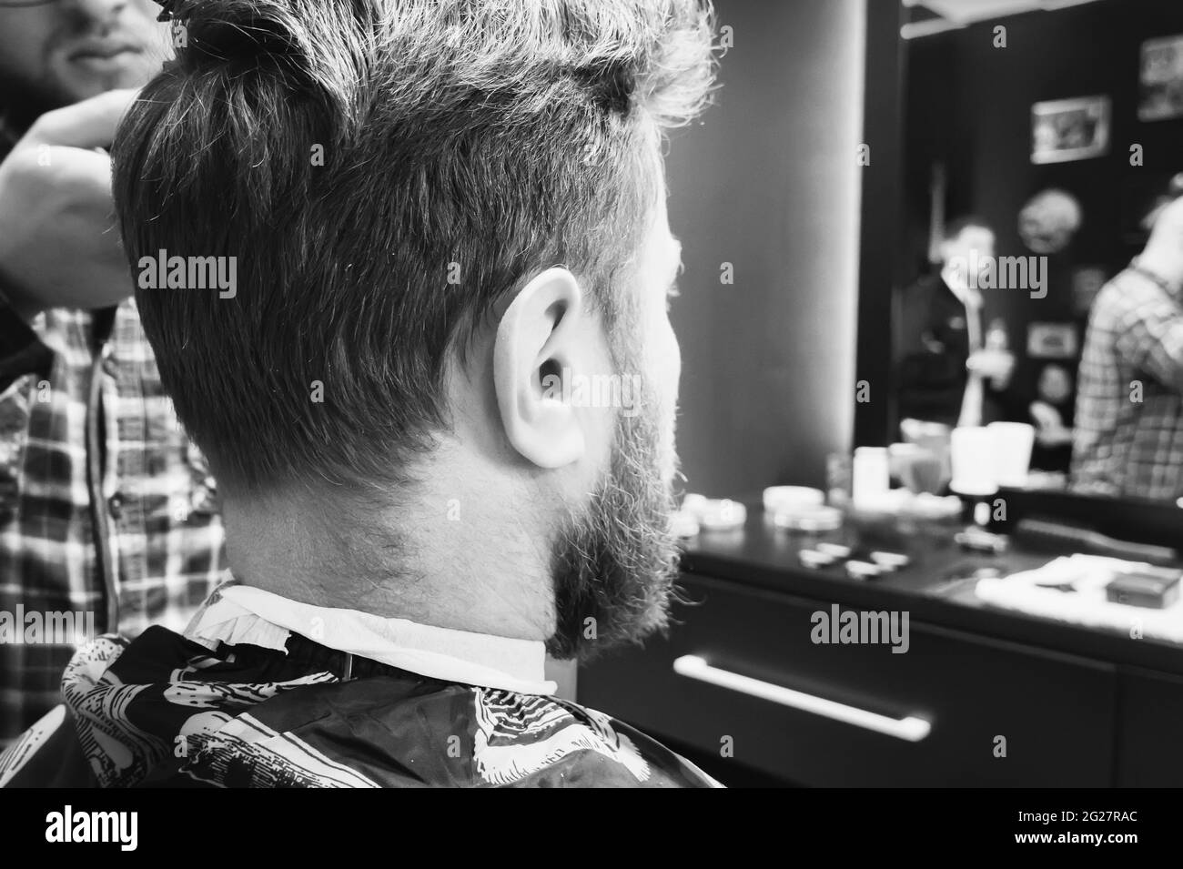 Barber cutting beard caucasian male Black and White Stock Photos ...