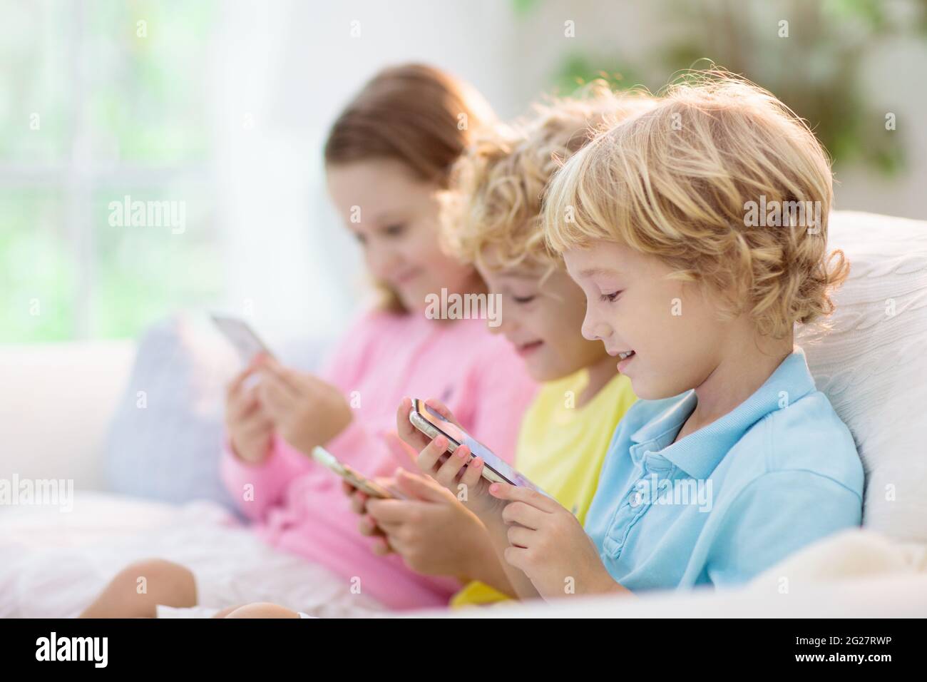 Kids with mobile phone. Child with tablet computer watching movie or ...