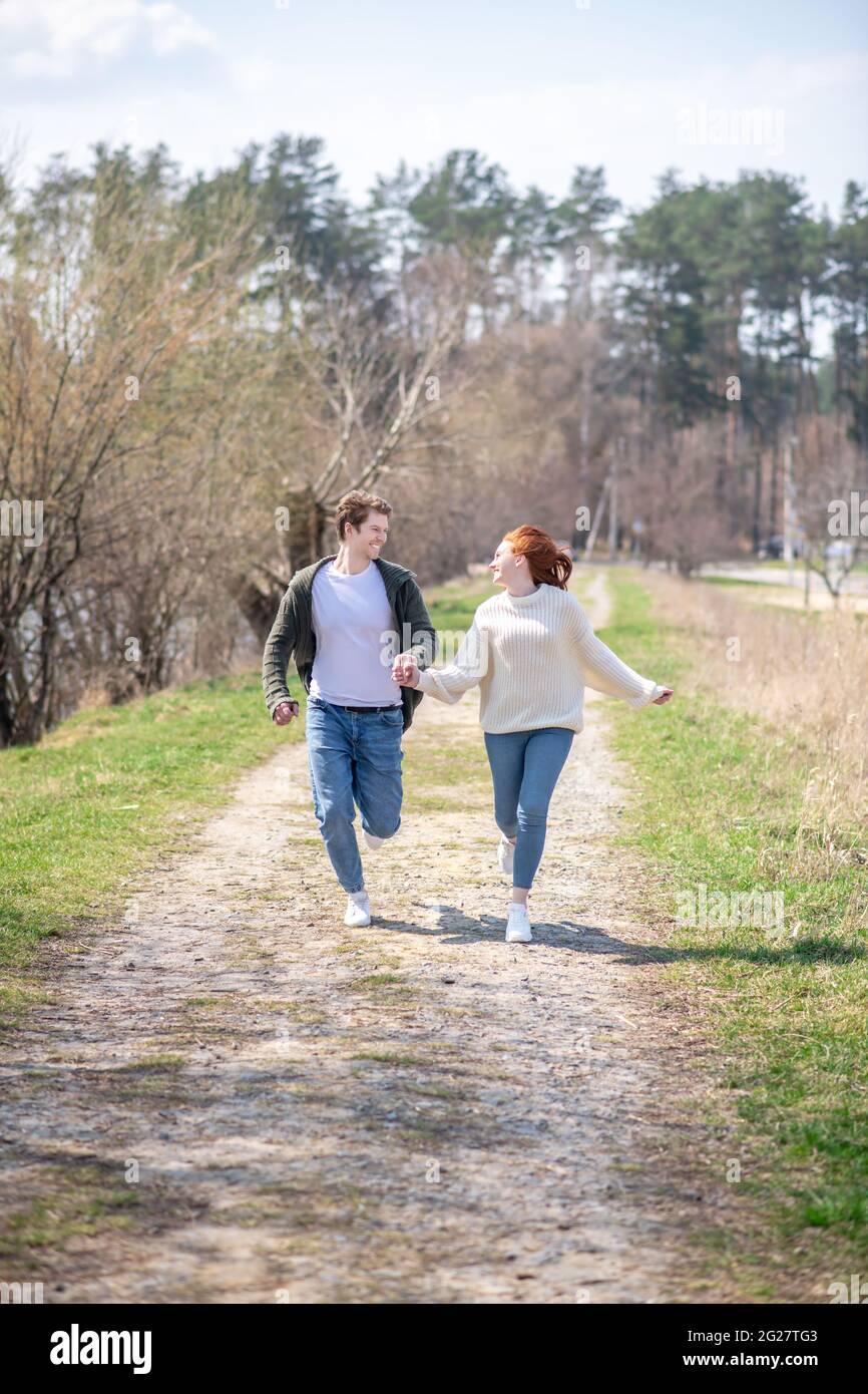 Family running hand in hand hi-res stock photography and images - Alamy