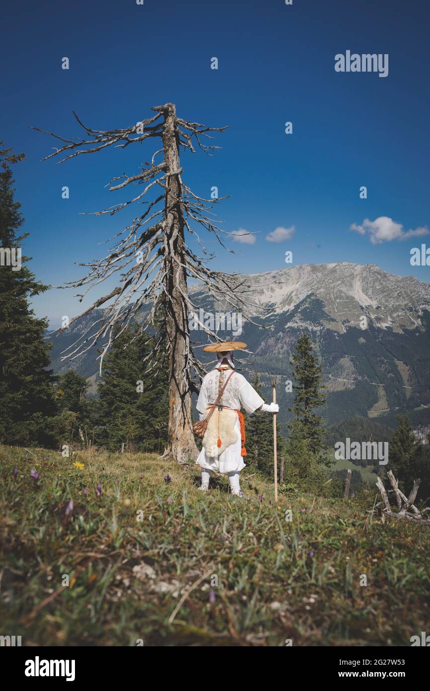 European Shugendo monk in traditional outfit hiking in the Austrian ...