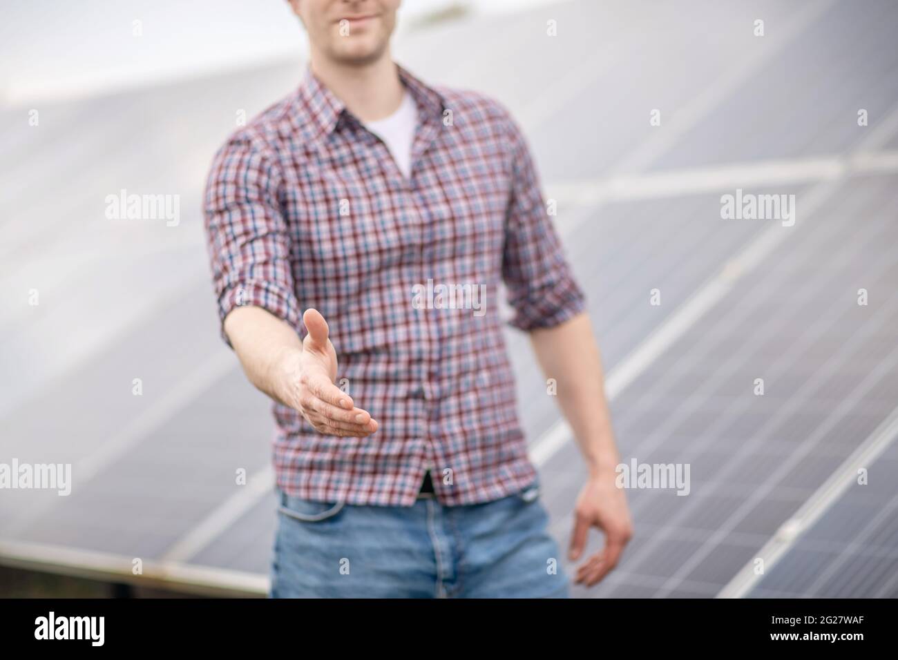 Man extending his hand forward in greeting Stock Photo - Alamy