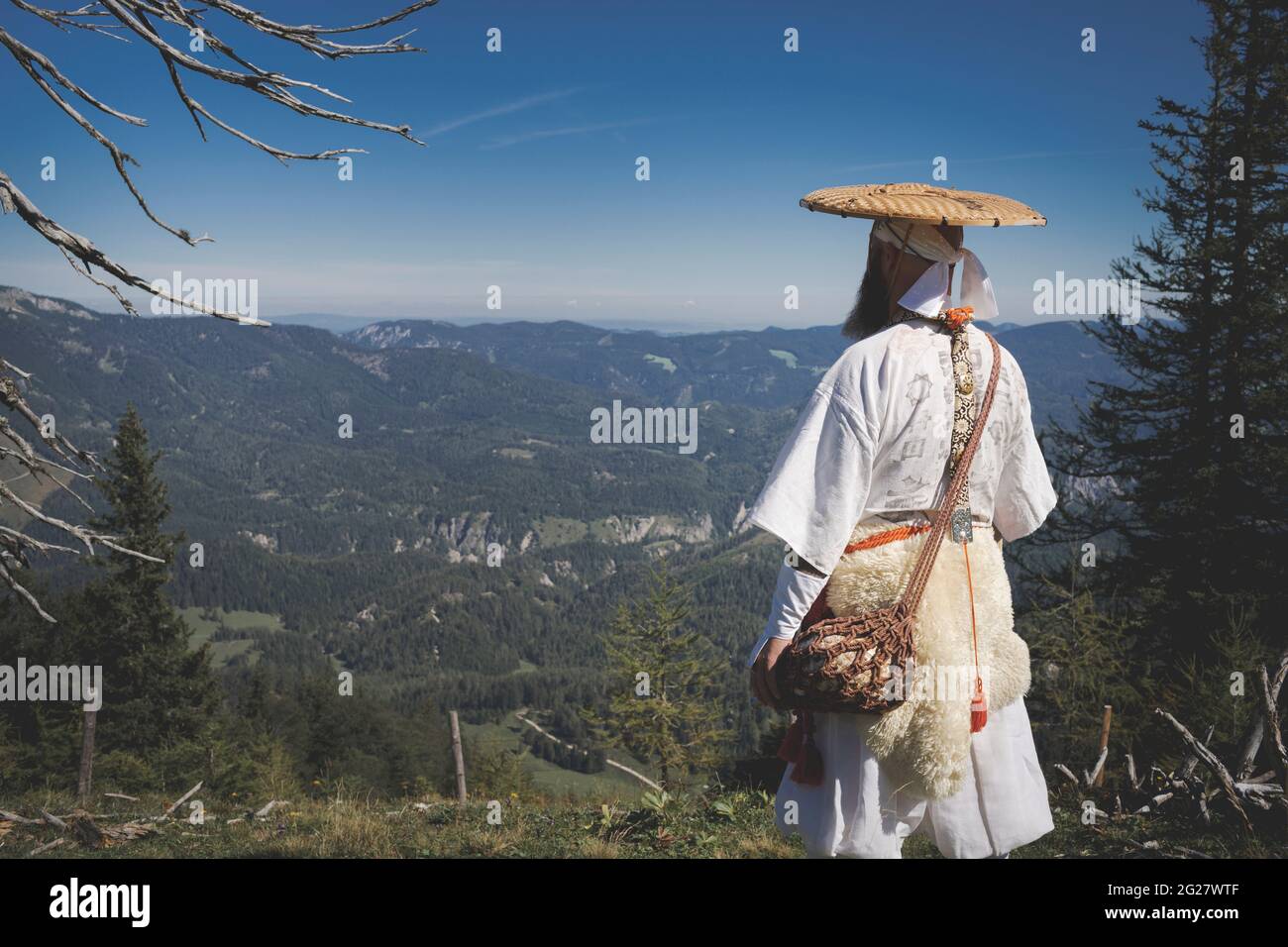 European Shugendo monk in traditional outfit hiking in the Austrian ...