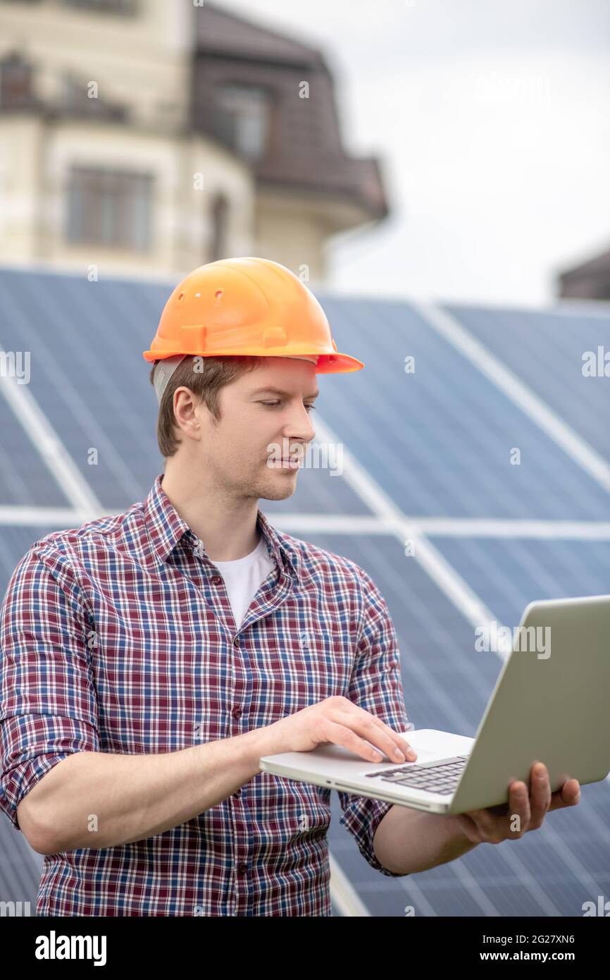 Profile of man in helmet with laptop Stock Photo - Alamy