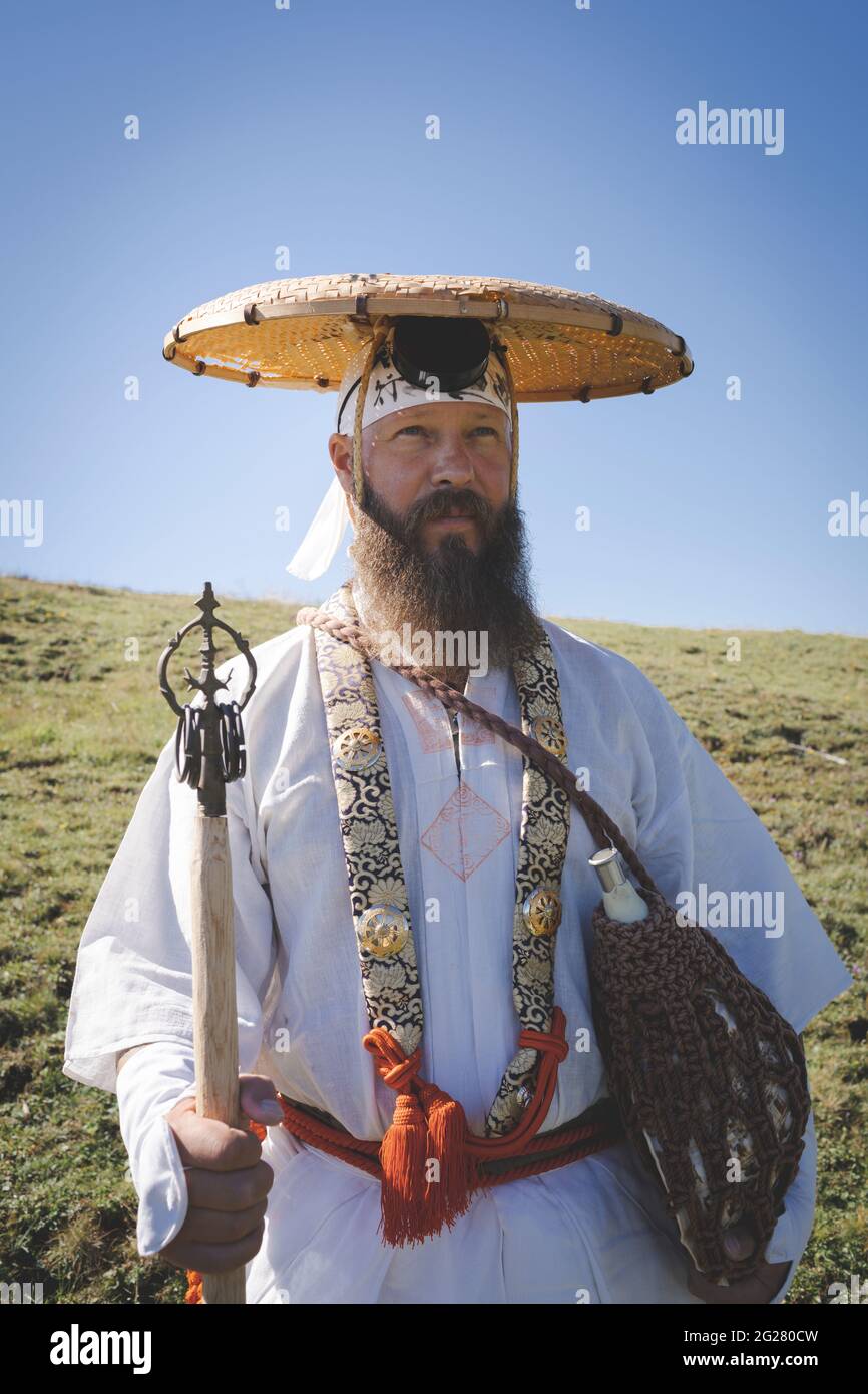 European Shugendo monk in traditional outfit hiking in the Austrian ...