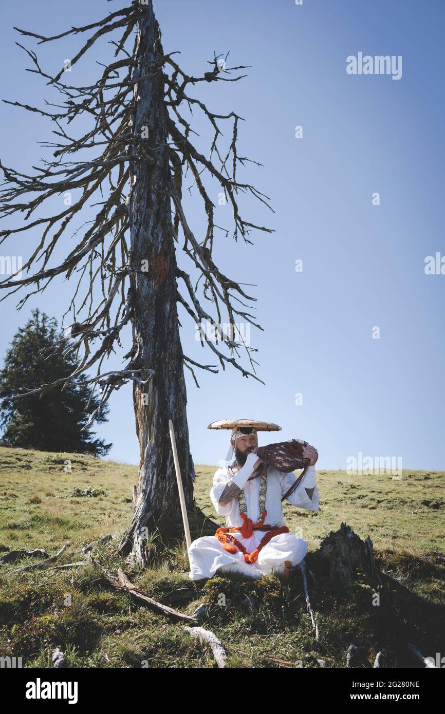 European Shugendo monk in traditional outfit hiking in the Austrian ...