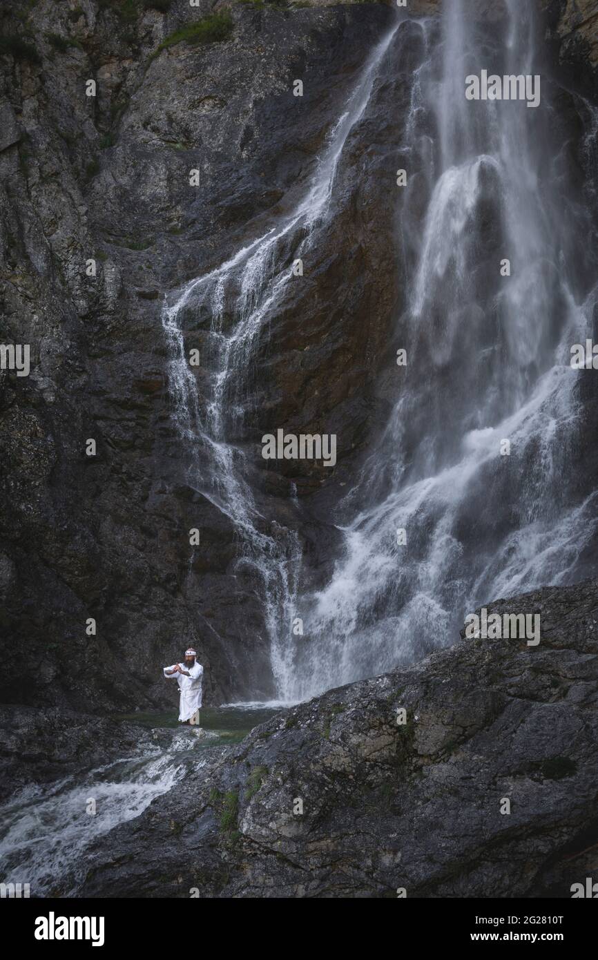European Shugendo monk in traditional outfit hiking in the Austrian ...