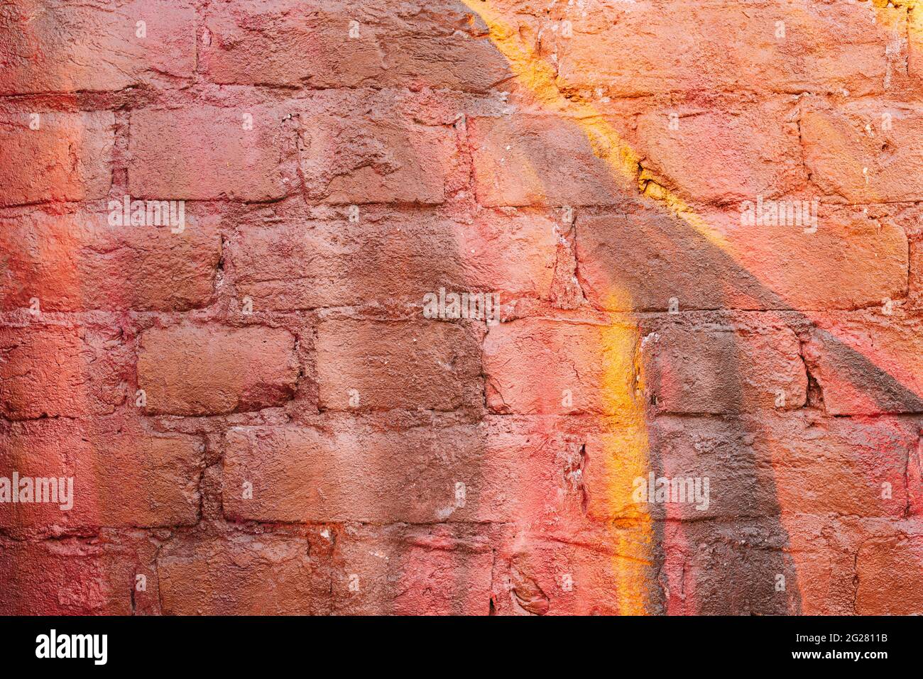 Multi-colored brick wall in vibrant burgundy and yellow colors Stock ...