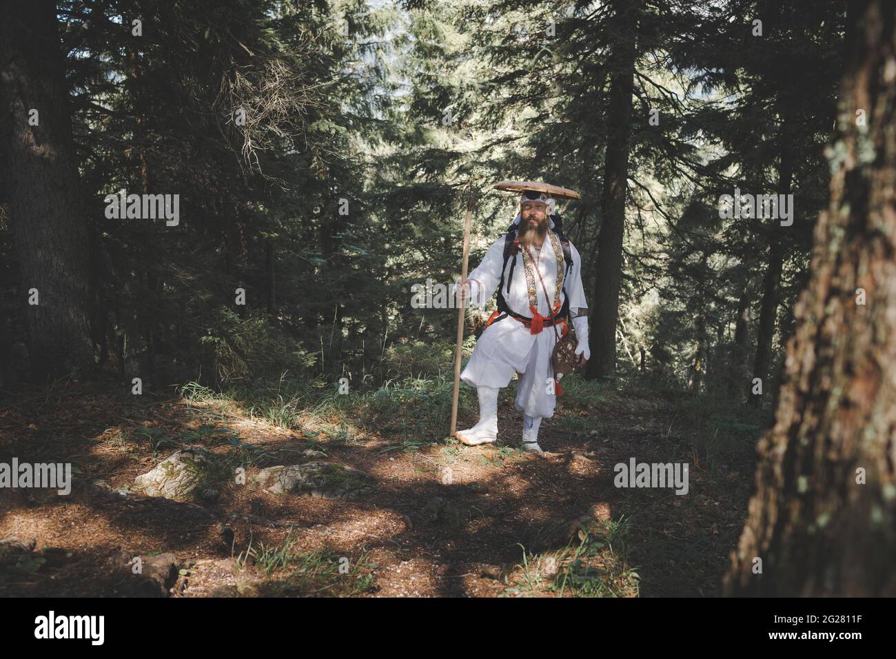 European Shugendo monk in traditional outfit hiking in the Austrian ...