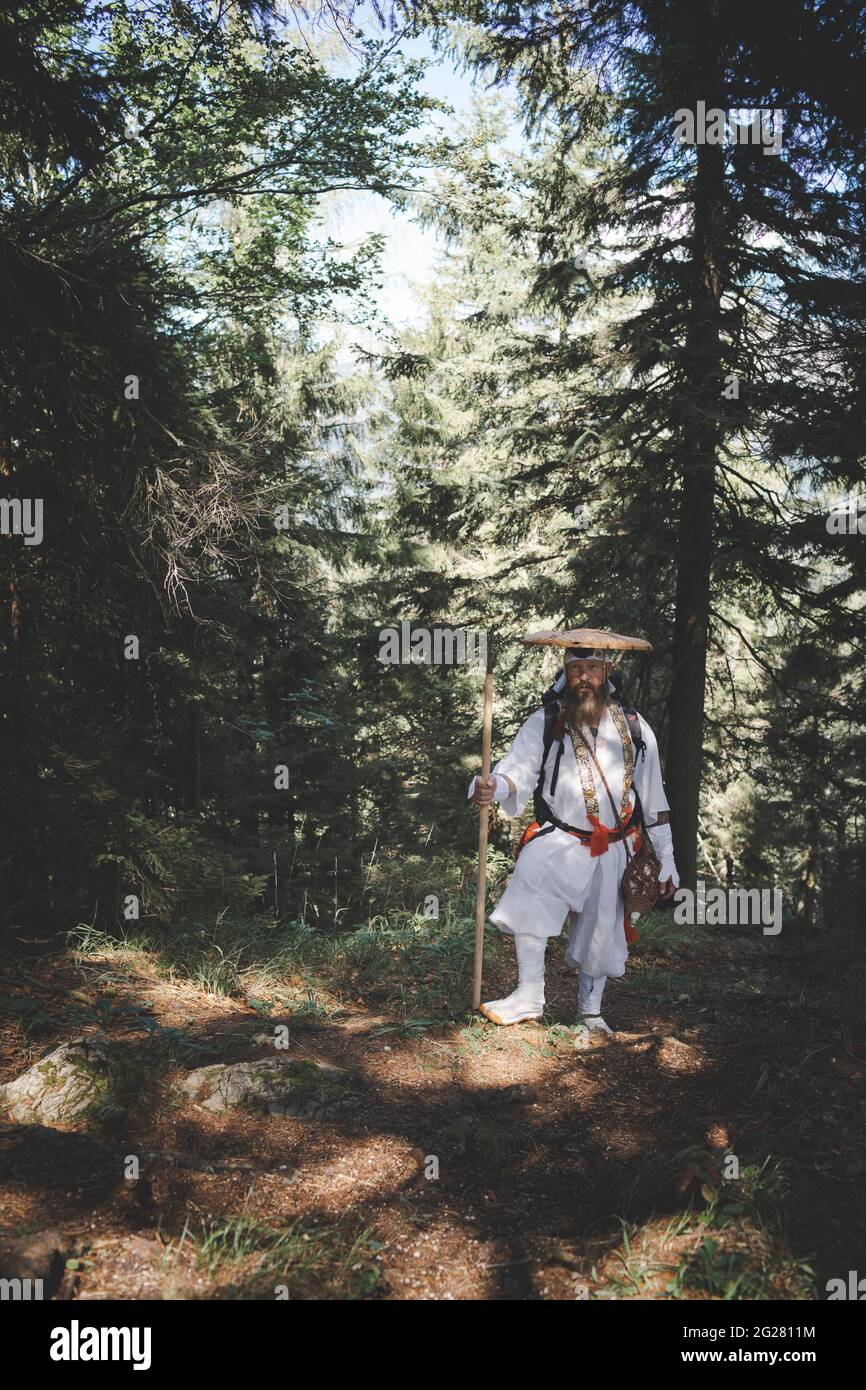European Shugendo monk in traditional outfit hiking in the Austrian ...