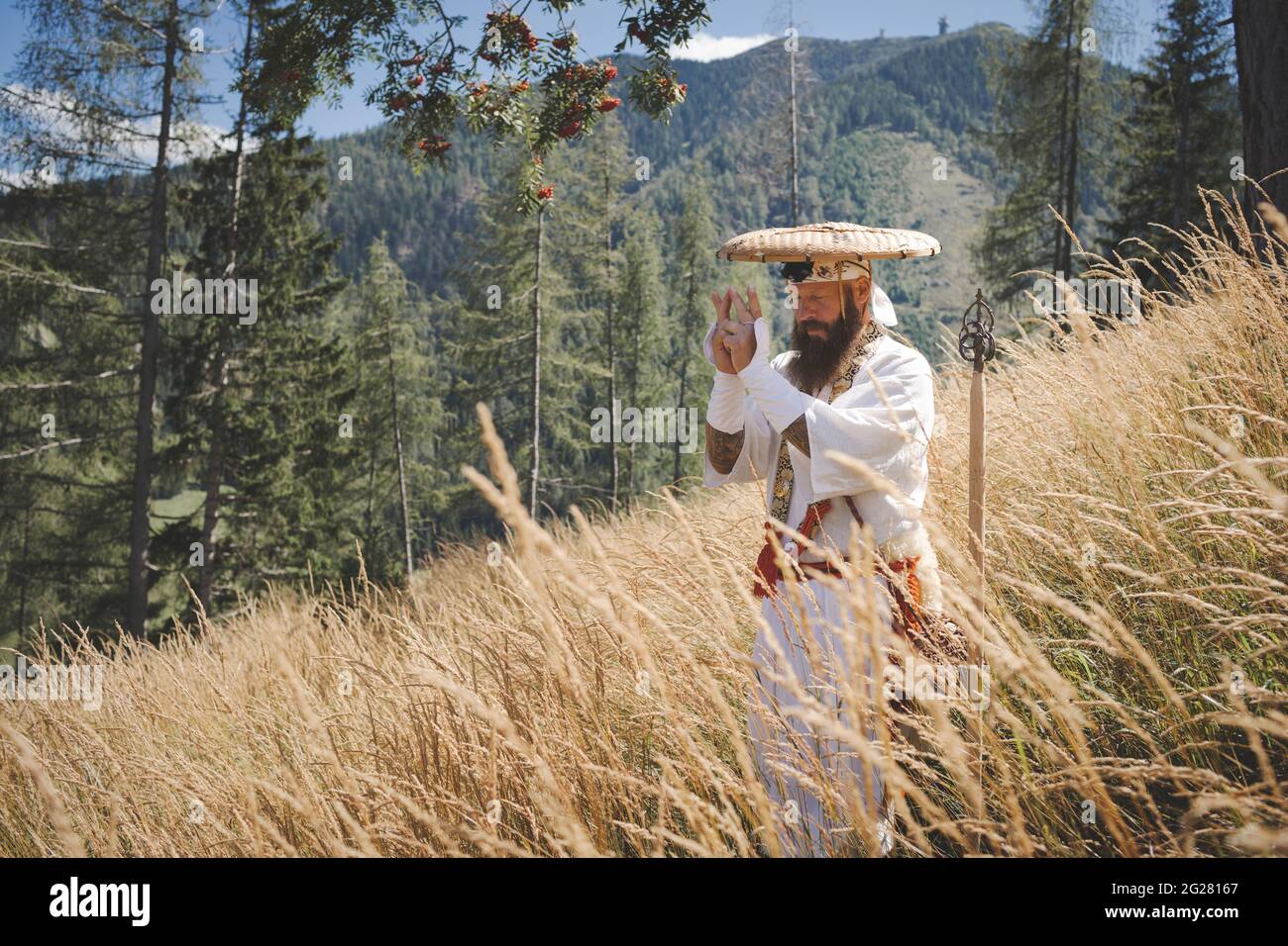 European Shugendo monk in traditional outfit hiking in the Austrian ...