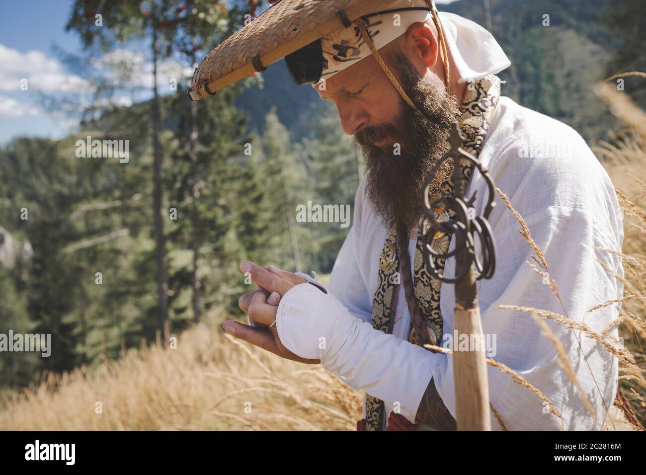 European Shugendo monk in traditional outfit hiking in the Austrian ...