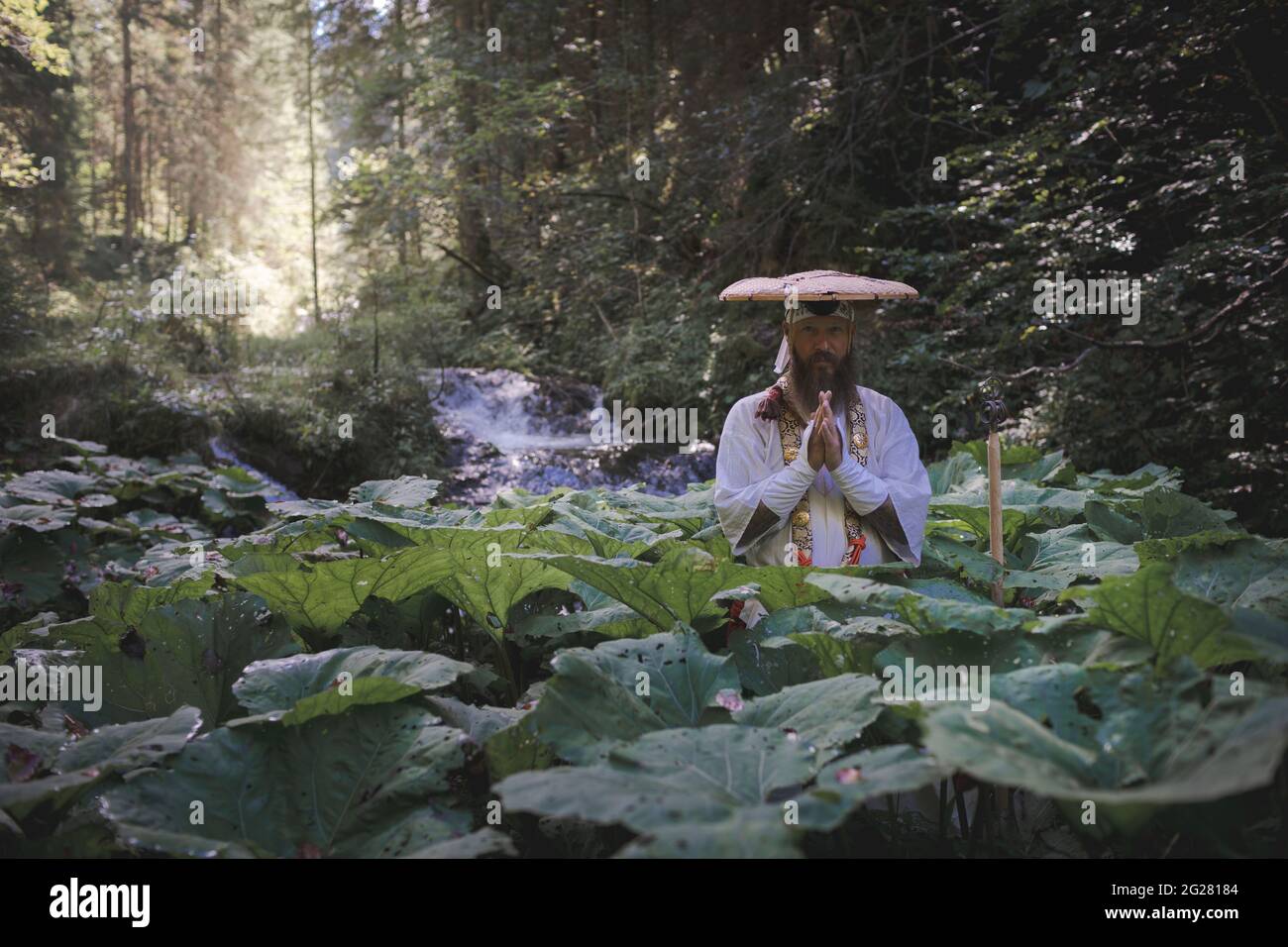 European Shugendo monk in traditional outfit hiking in the Austrian ...