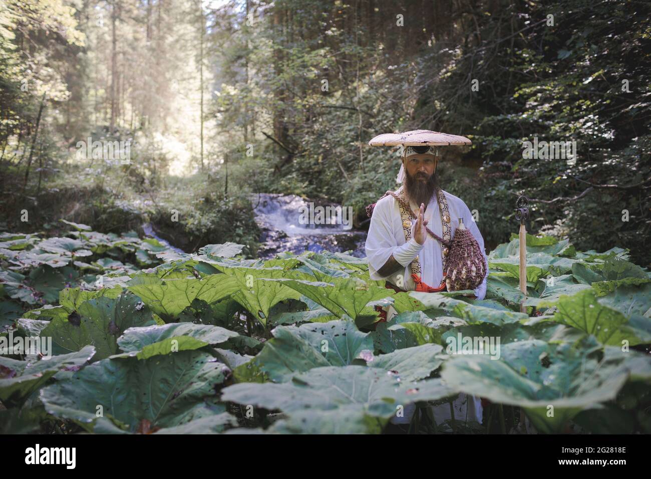 European Shugendo monk in traditional outfit hiking in the Austrian ...