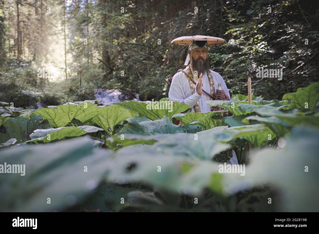 European Shugendo monk in traditional outfit hiking in the Austrian ...
