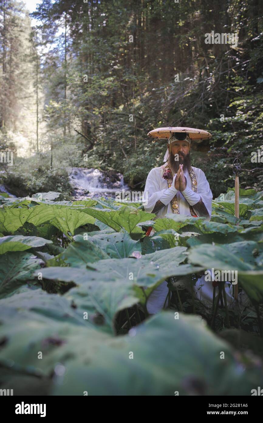 European Shugendo monk in traditional outfit hiking in the Austrian ...