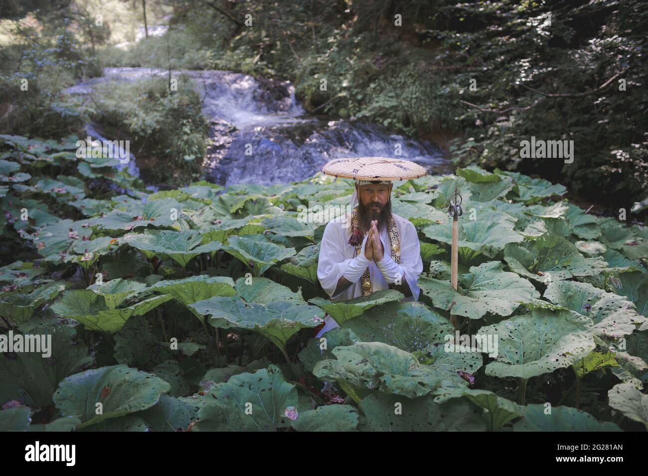 European Shugendo monk in traditional outfit hiking in the Austrian ...