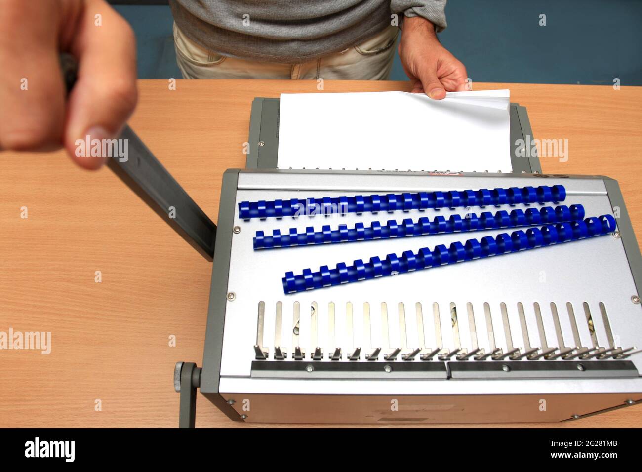 male man binding pages at table in paper store Stock Photo - Alamy