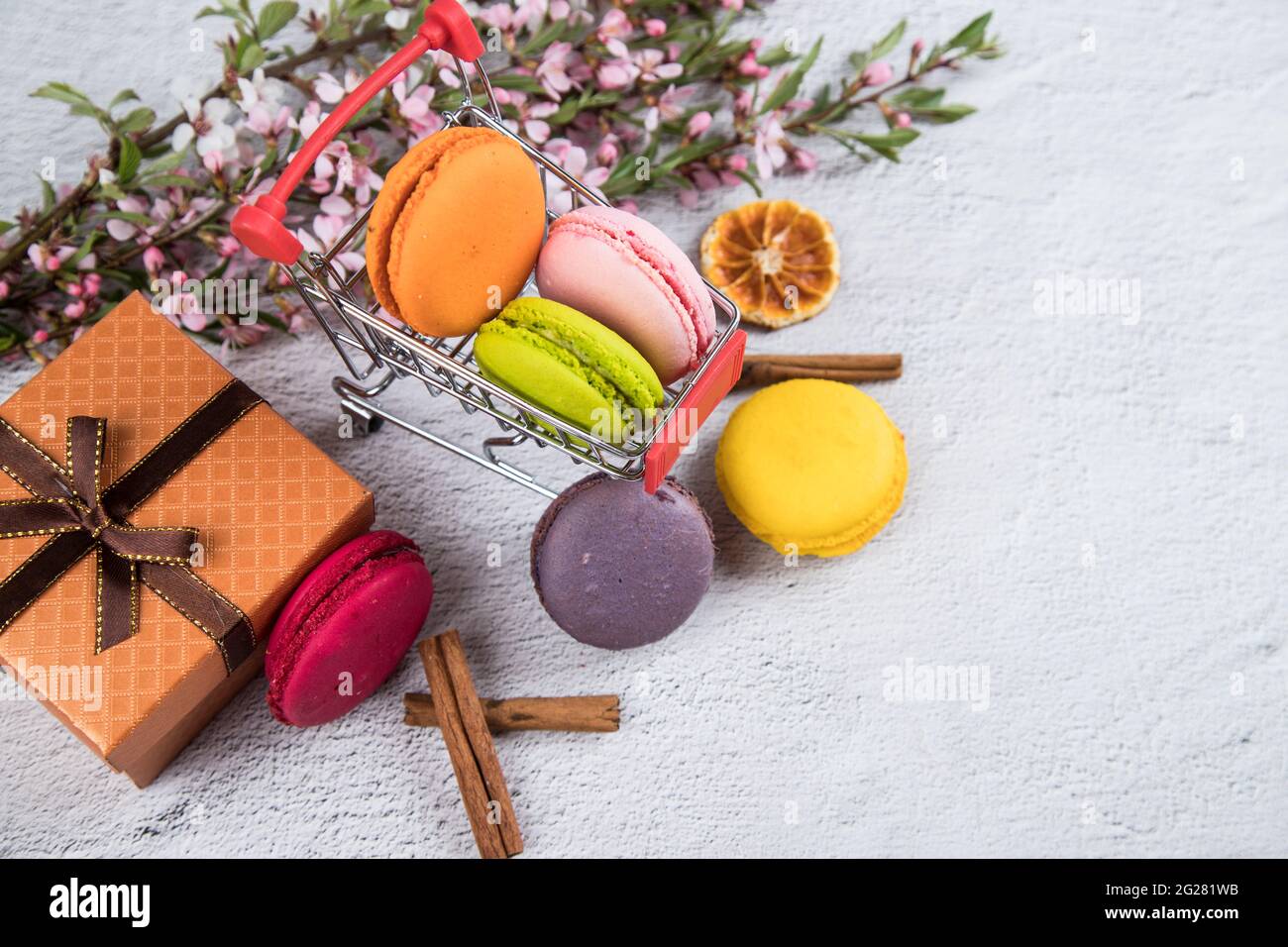 Souvenir food cart with macaroons cookies on a light background with ...