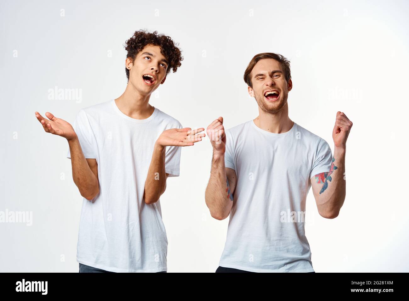 two funny friends in white t-shirts laughing positive emotions Stock ...