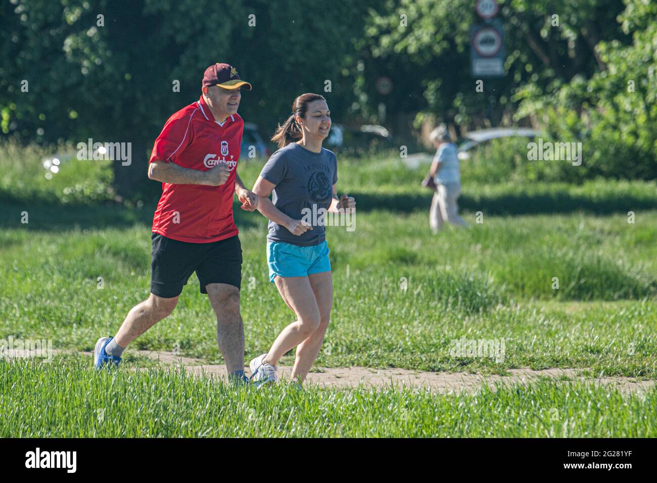 WIMBLEDON LONDON 9 June 2021 . A man and woman jogging together on ...