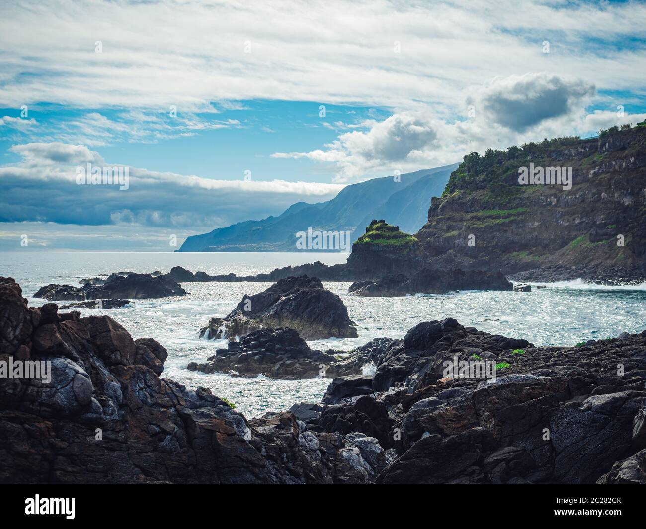 Beautiful view of a sea with rocky coasts under a cloudy sky Stock ...