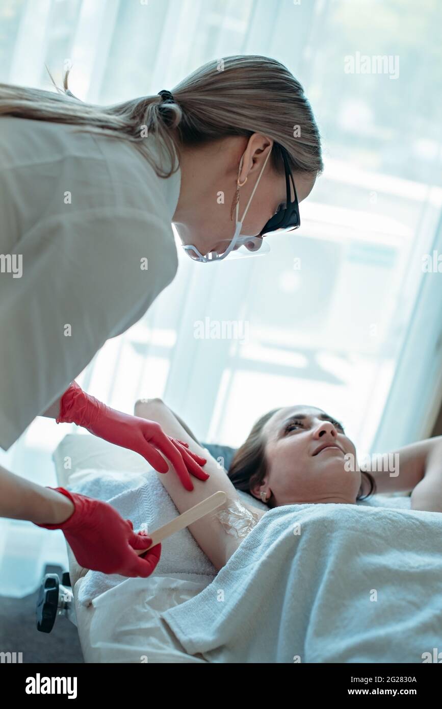 A woman beautician makes a diode laser epilation procedure Stock Photo ...