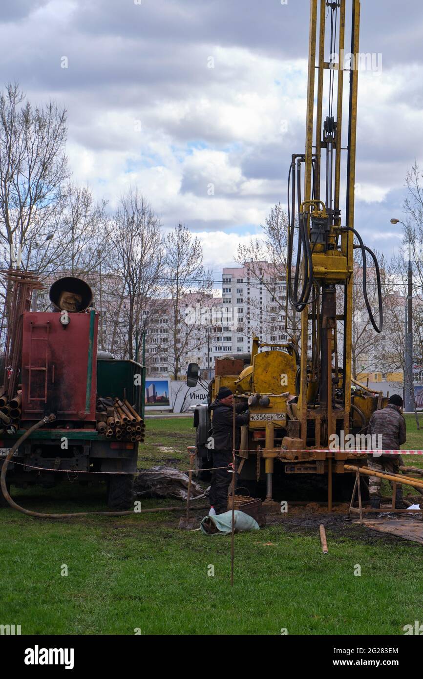 Drilling rig on truck, buildings on city street - Moscow, Russia, April ...