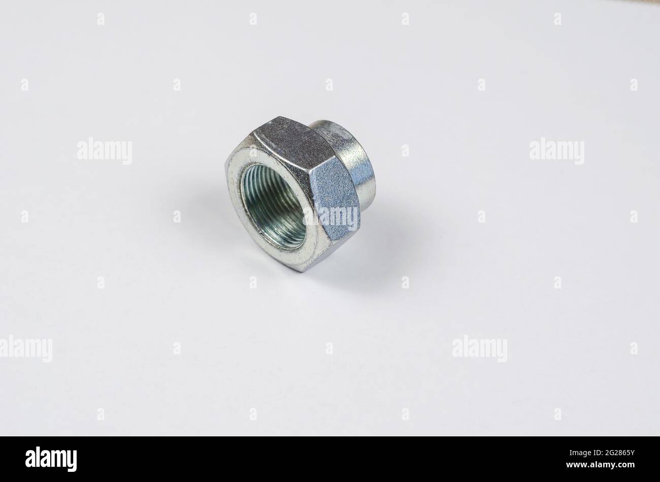 Hub nut on white background. New Silver front car hub nut. Auto parts ...