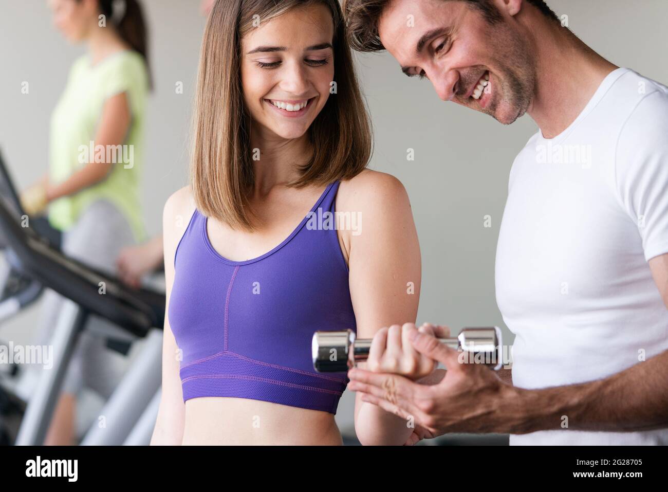Happy fit fitness girl exercising indoor in fitness center Stock Photo ...