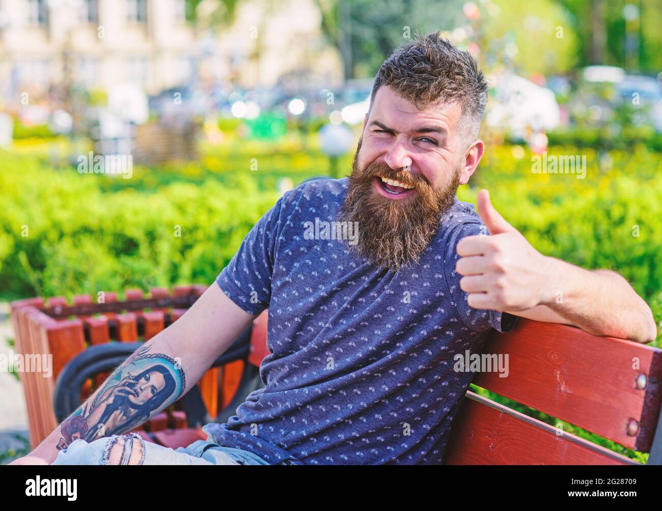 Rest and relax concept. Bearded man with fresh haircut relaxing, urban ...