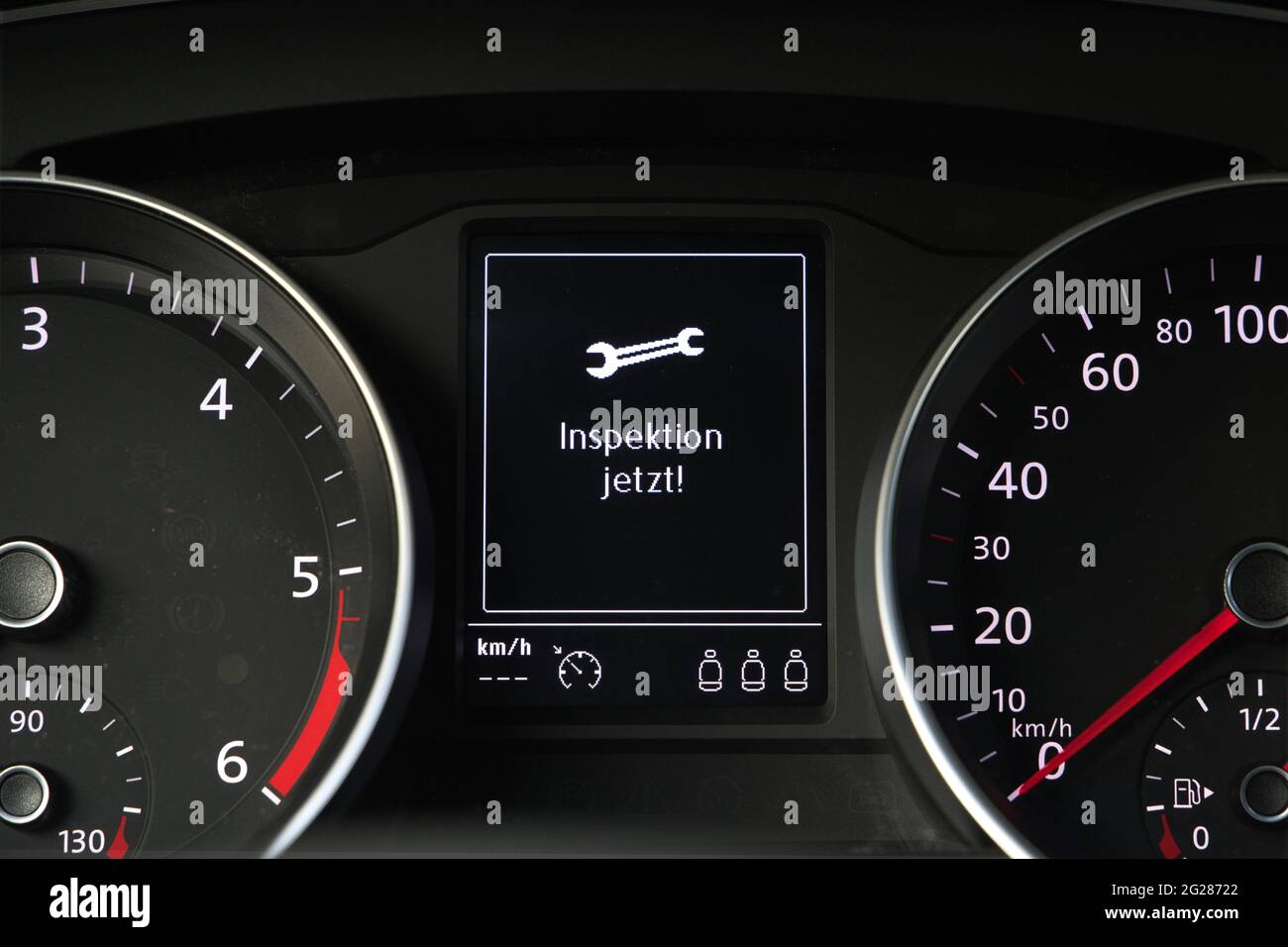 Closeup shot of a display in a car cockpit with "service now" text in ...