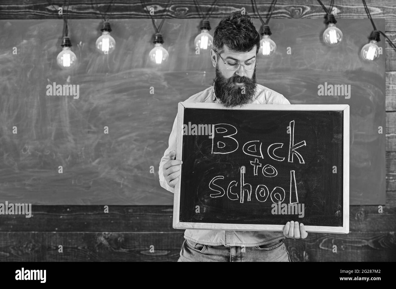 Back to school concept. Man with beard and mustache on surprised face ...