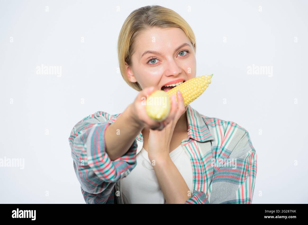 woman eating a delicious corncob. Happy woman eating corn. vegetable ...