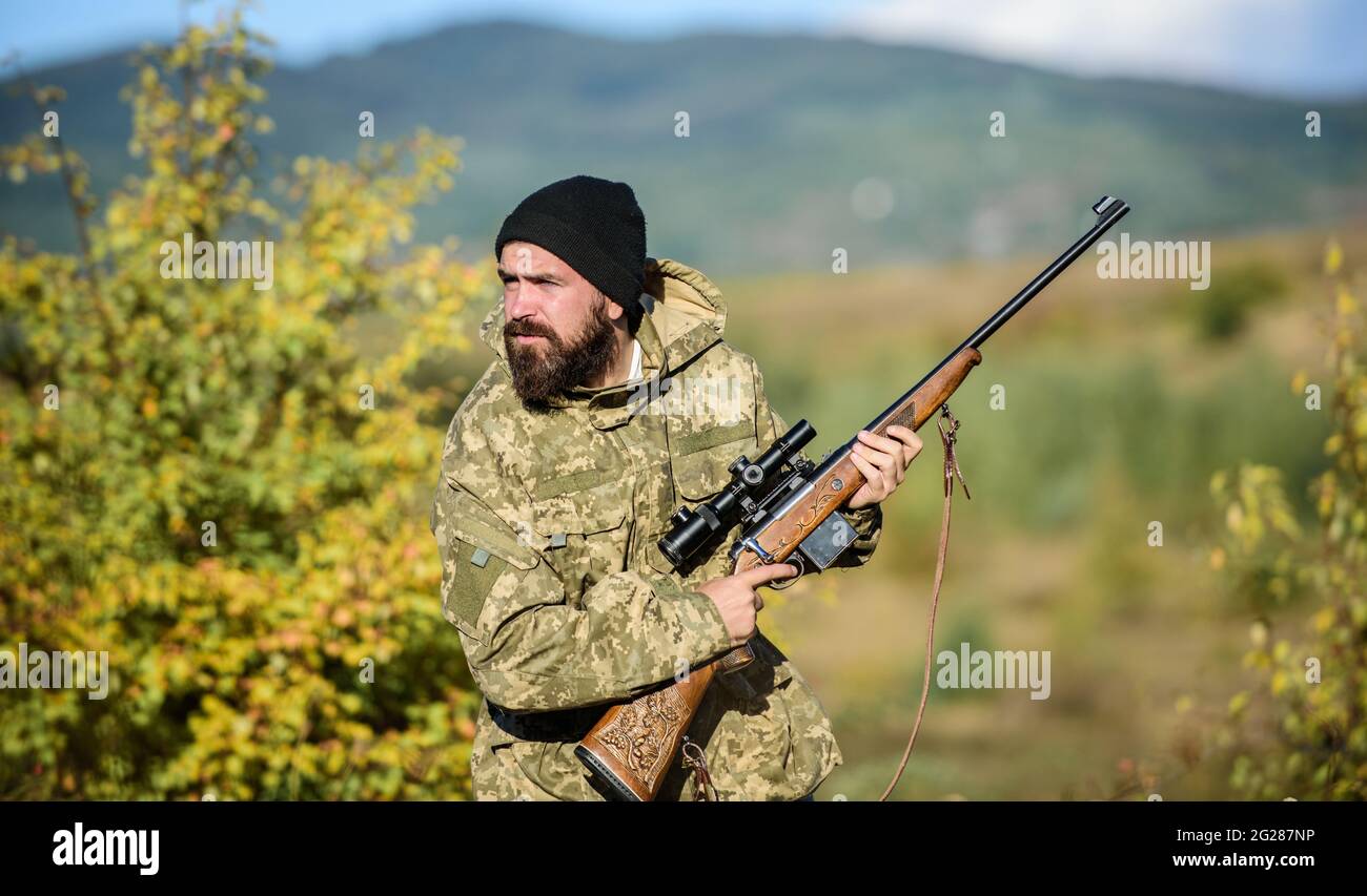 Hunter hold rifle. Bearded hunter spend leisure hunting. Focus and ...