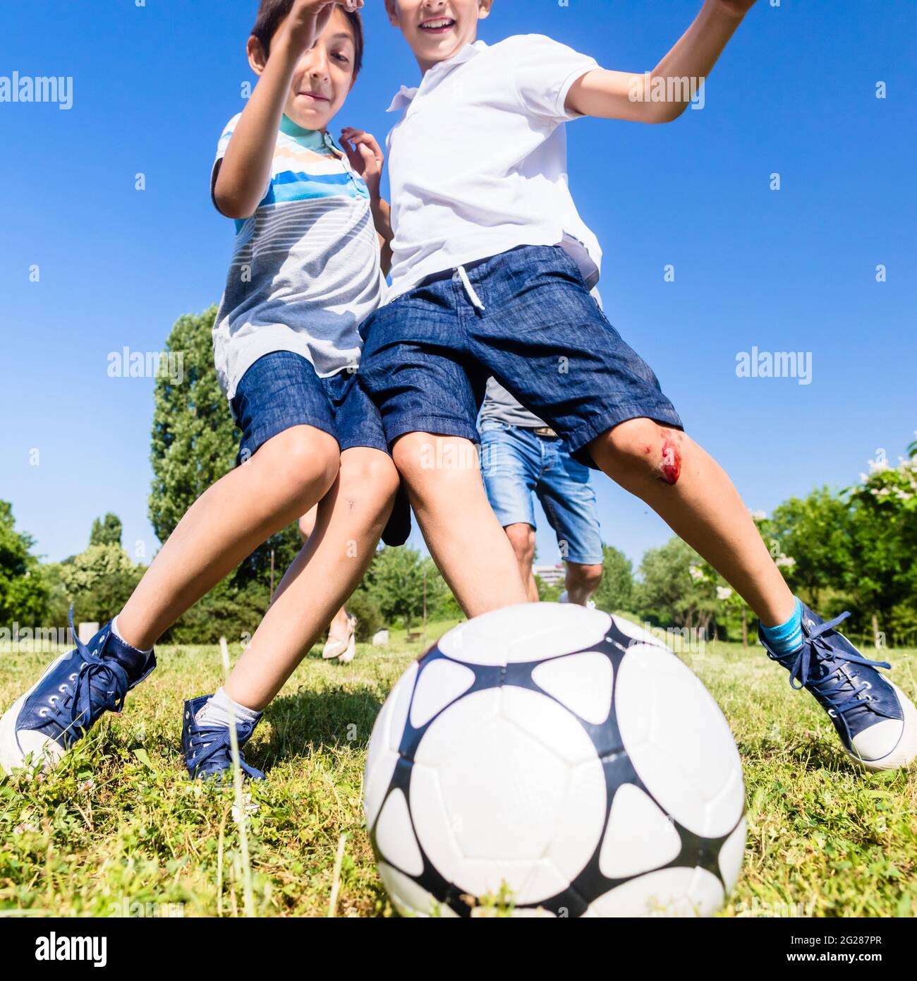 Happy family playing football in park in summer Stock Photo - Alamy