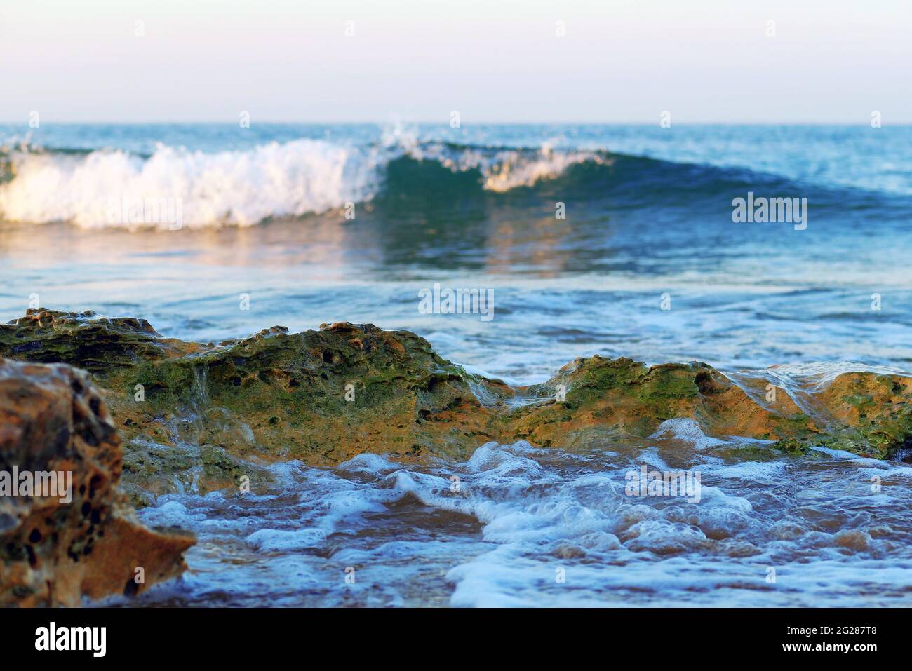 rocks and rolling wave at background Stock Photo - Alamy