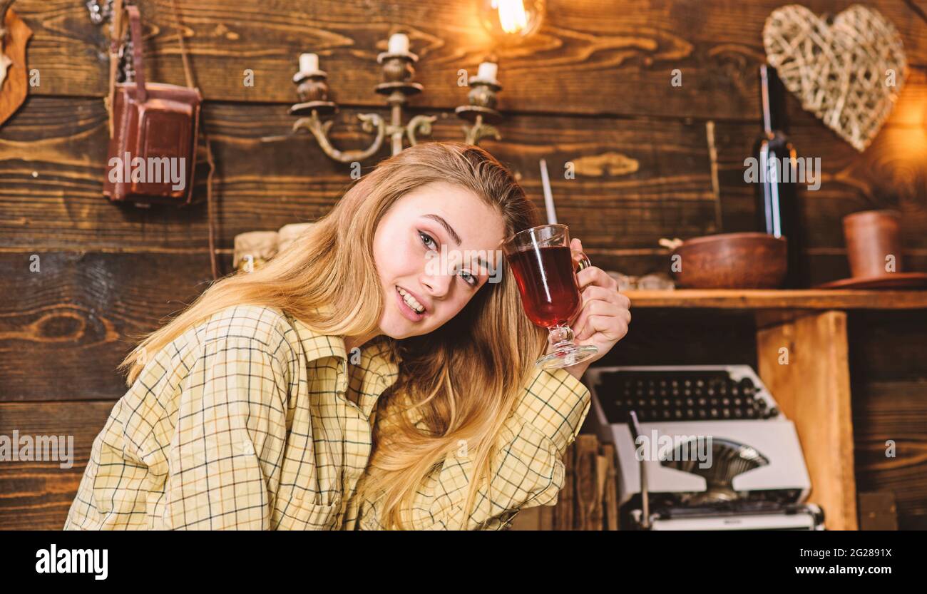 Girl tomboy relax with glass with mulled wine in house of gamekeeper ...