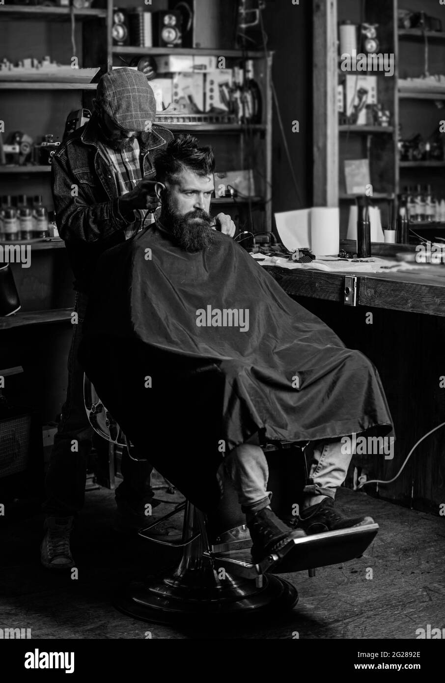 Hipster hairstyle concept. Hipster client getting haircut. Barber with ...