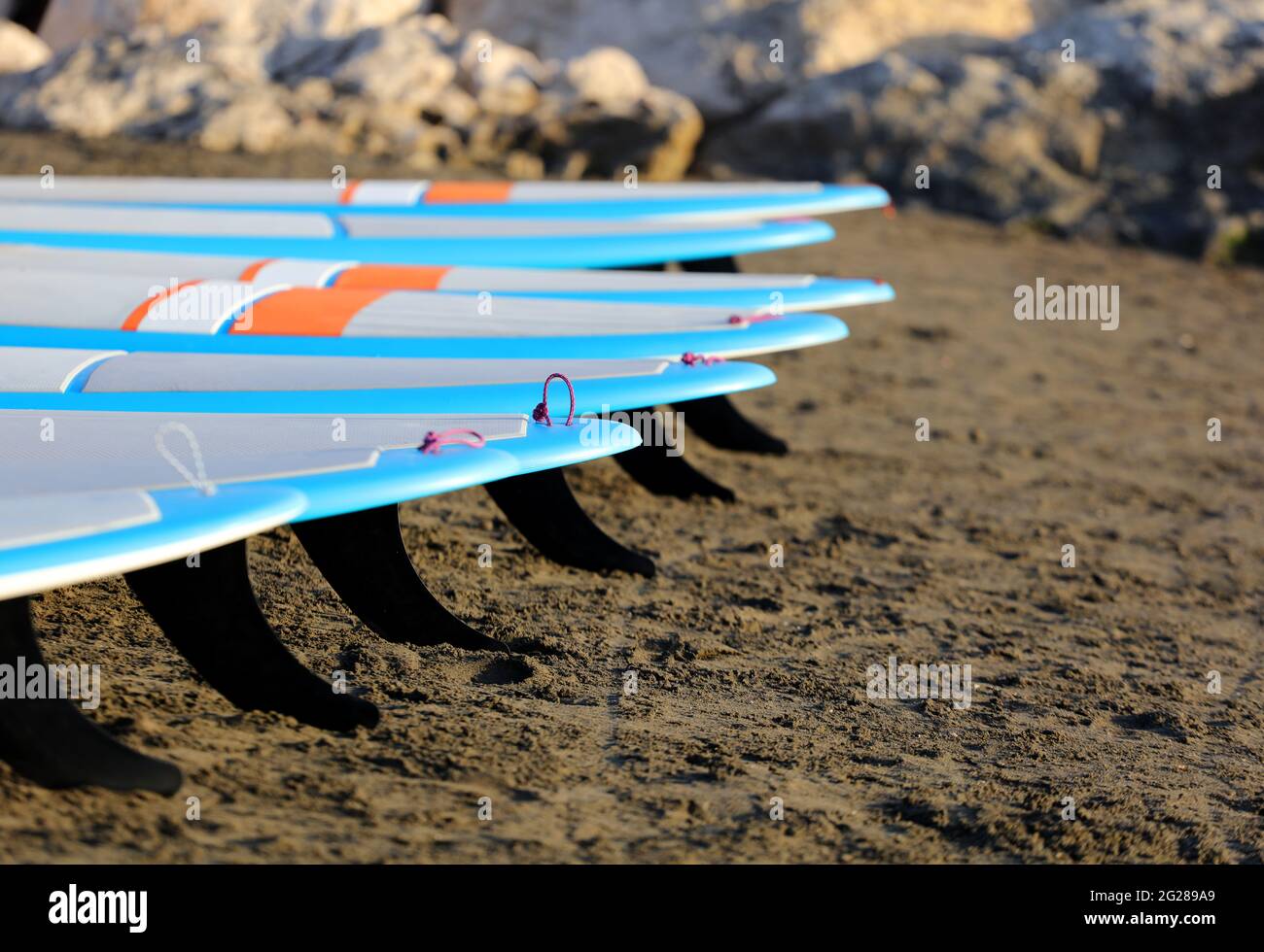 paddle boards, on the beach on the sand, at sunset Stock Photo - Alamy