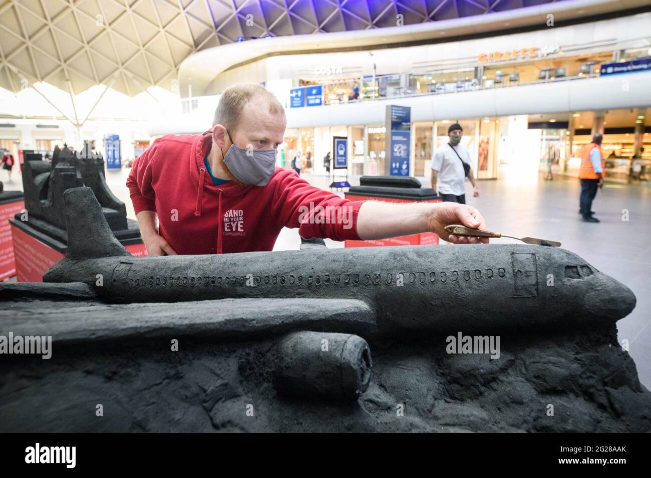 EDITORIAL USE ONLY Artist Jamie Wardley creates a series of sand ...