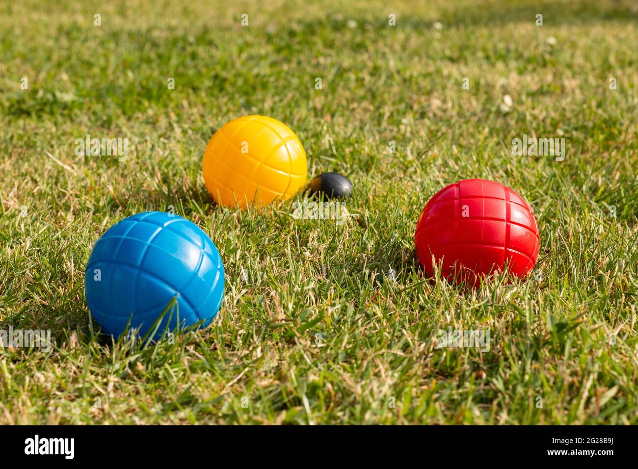 Boccia balls in primary colours blue, yellow and red Stock Photo - Alamy