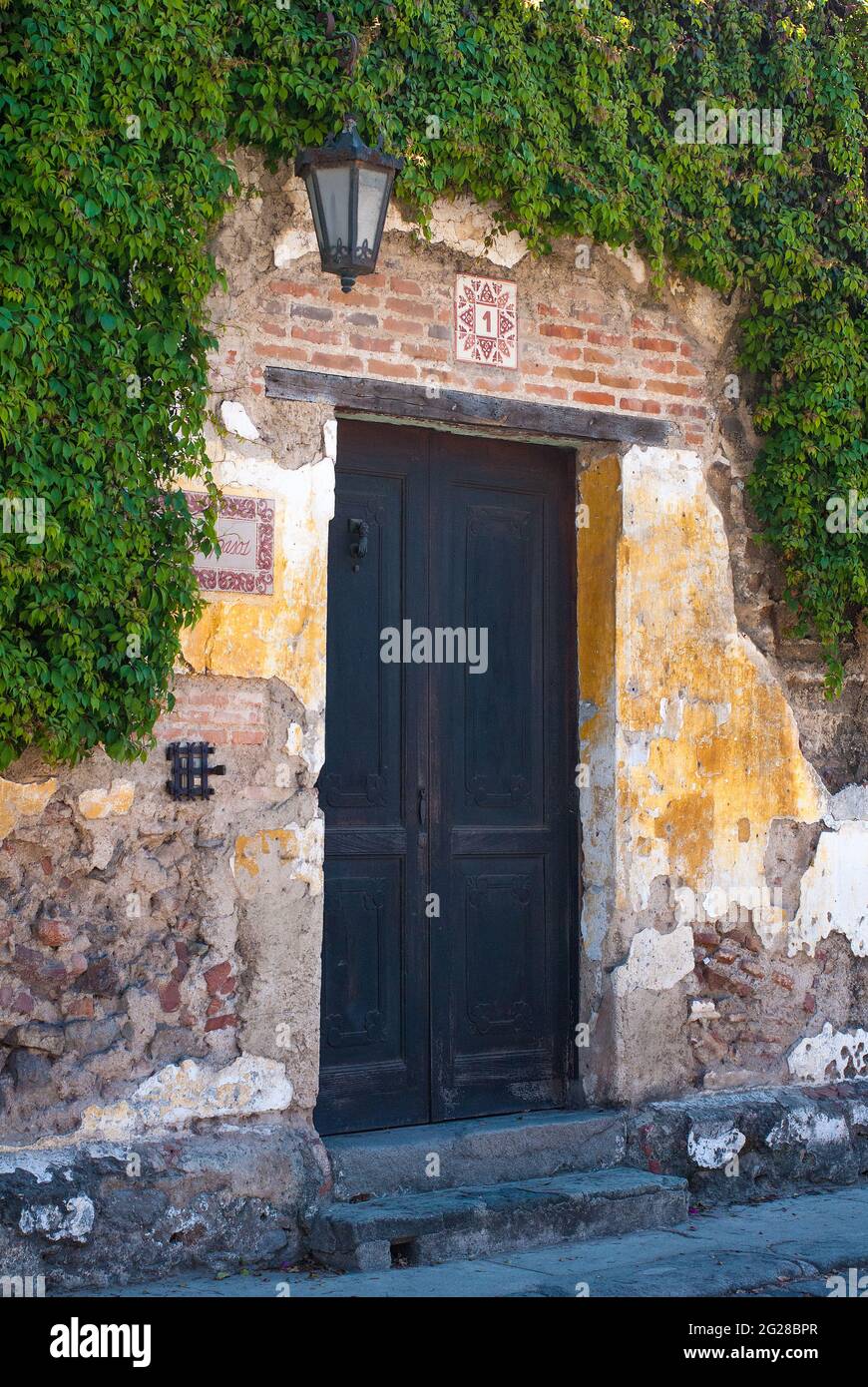 Rustic colonial style wall and large door painted black, made of wood ...