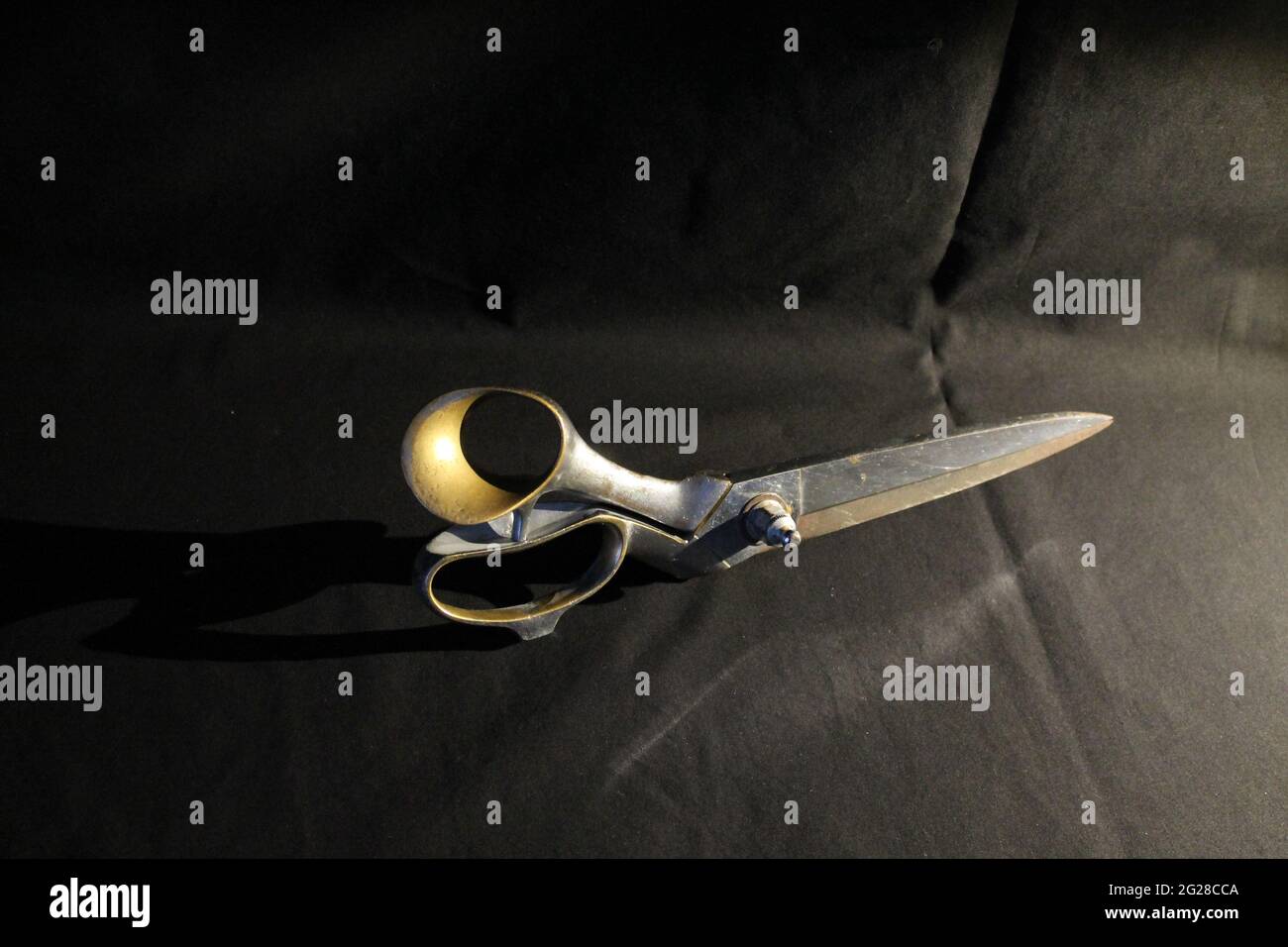 classic tailor scissors and tape measure on black background Stock ...