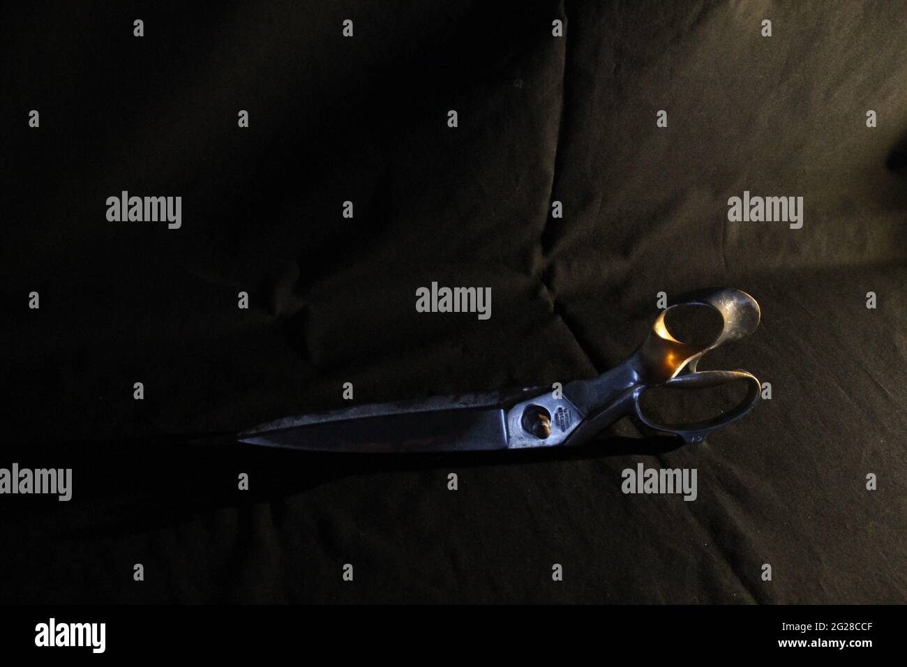 classic tailor scissors and tape measure on black background Stock ...