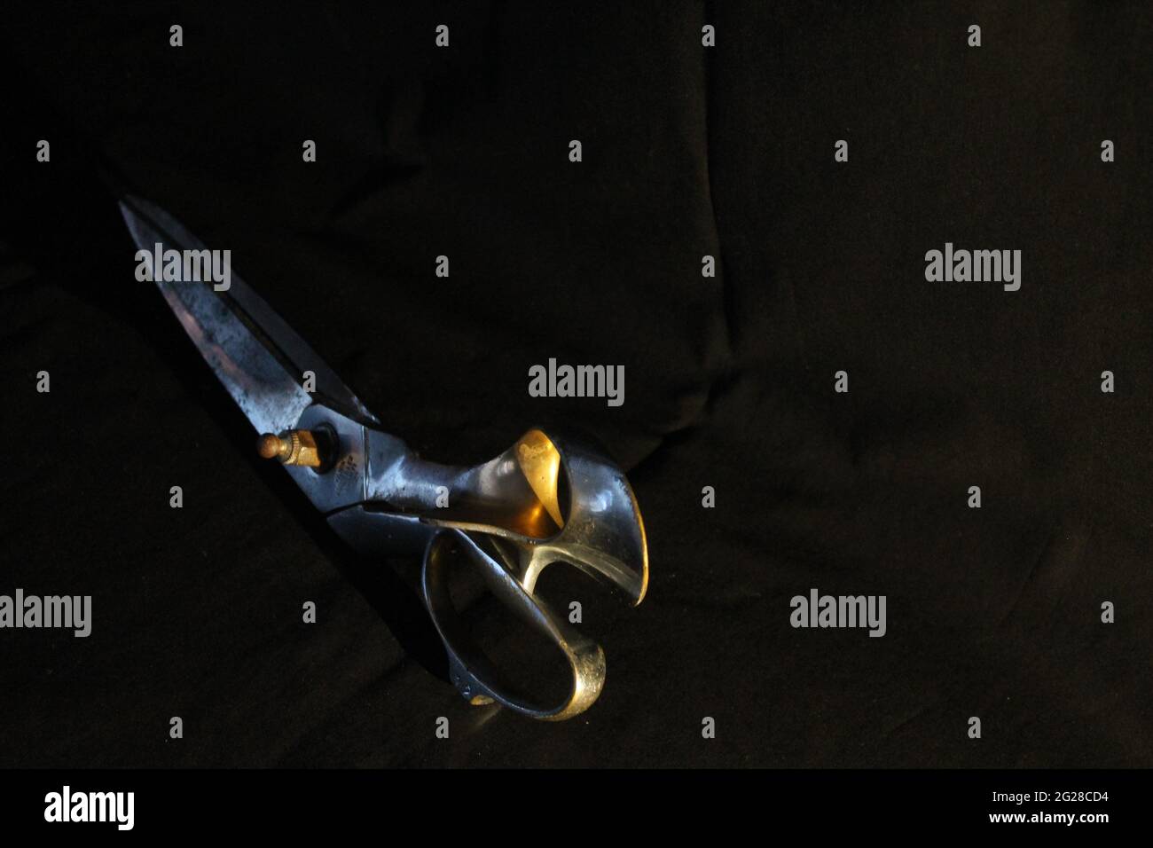 classic tailor scissors and tape measure on black background Stock ...