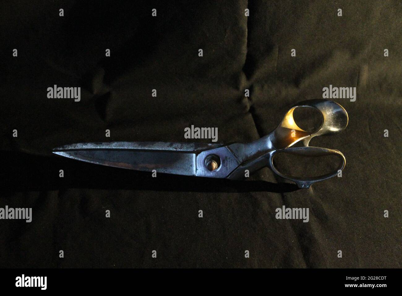 classic tailor scissors and tape measure on black background Stock ...