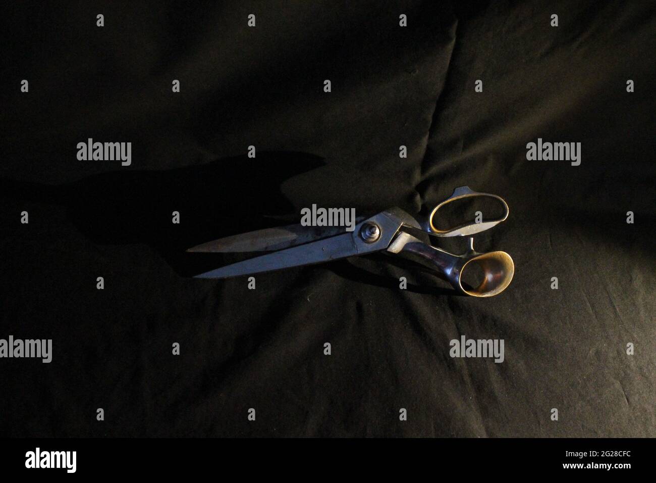 classic tailor scissors and tape measure on black background Stock ...