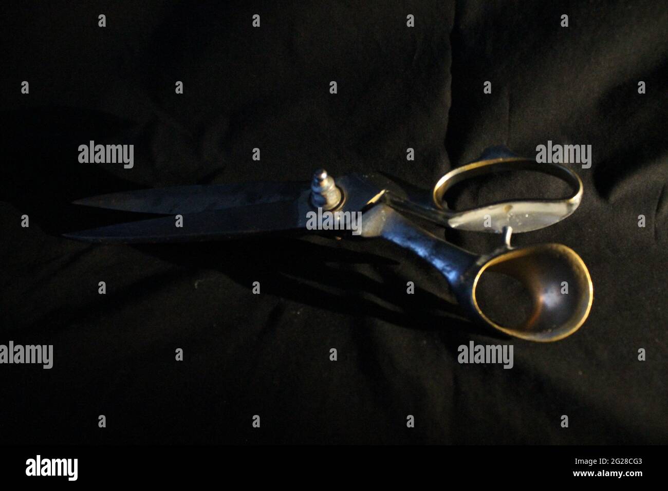 classic tailor scissors and tape measure on black background Stock ...